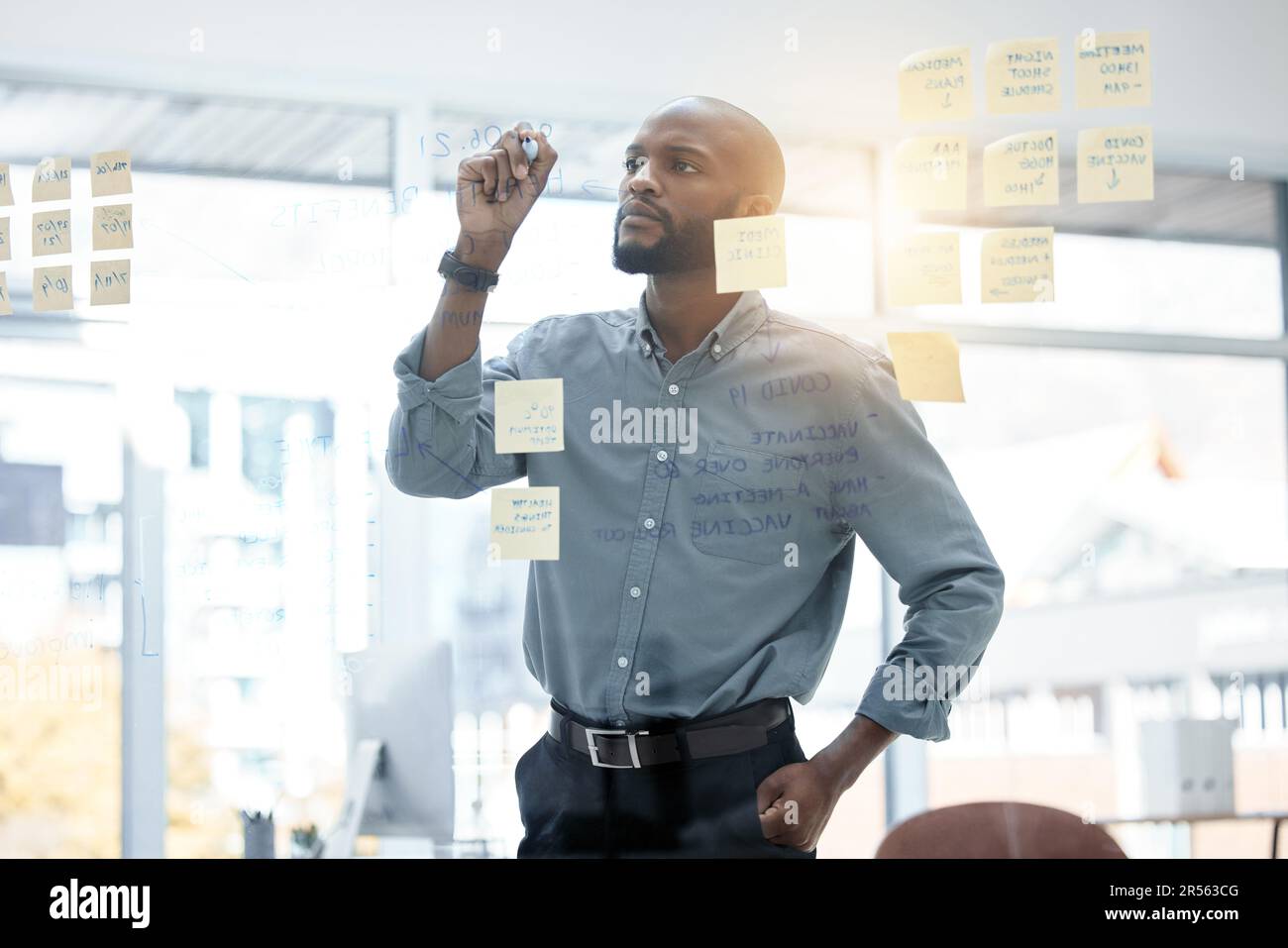 Planning, writing and business man on glass board for brainstorming ...