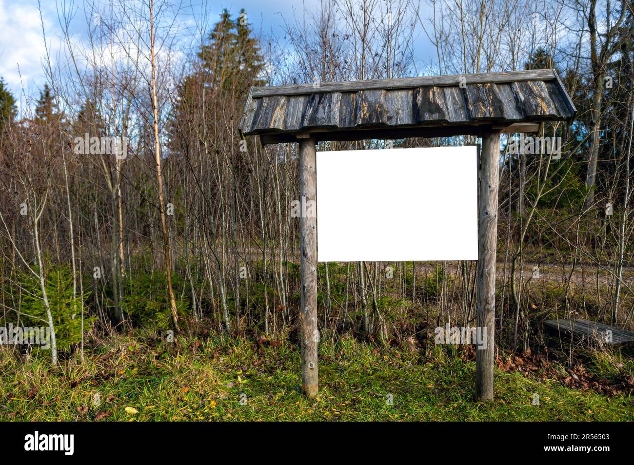 Empty wooden bulletin board outdoors with roof tiles, copy space ...