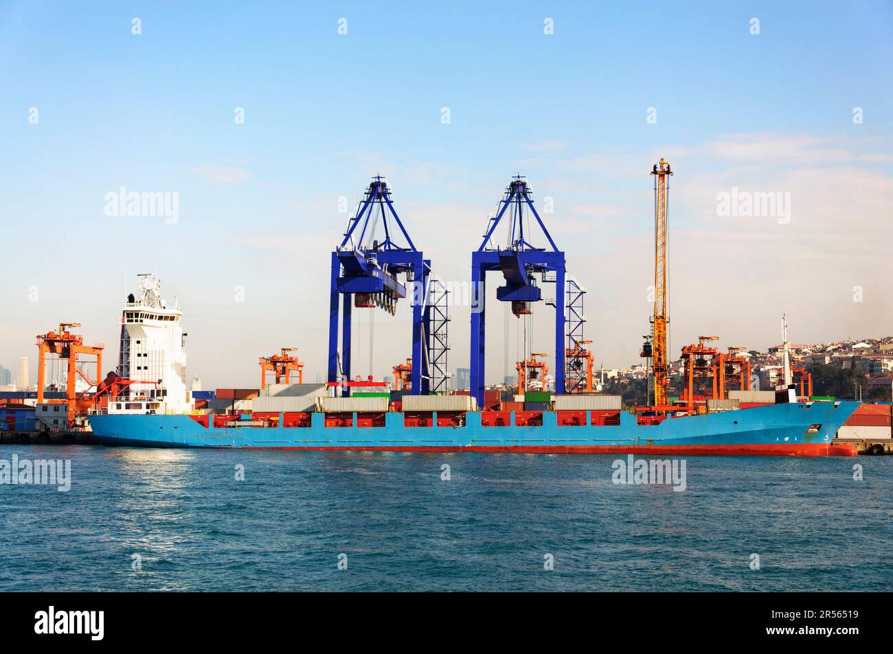 Container Cargo freight ship with working crane bridge in shipyard for ...