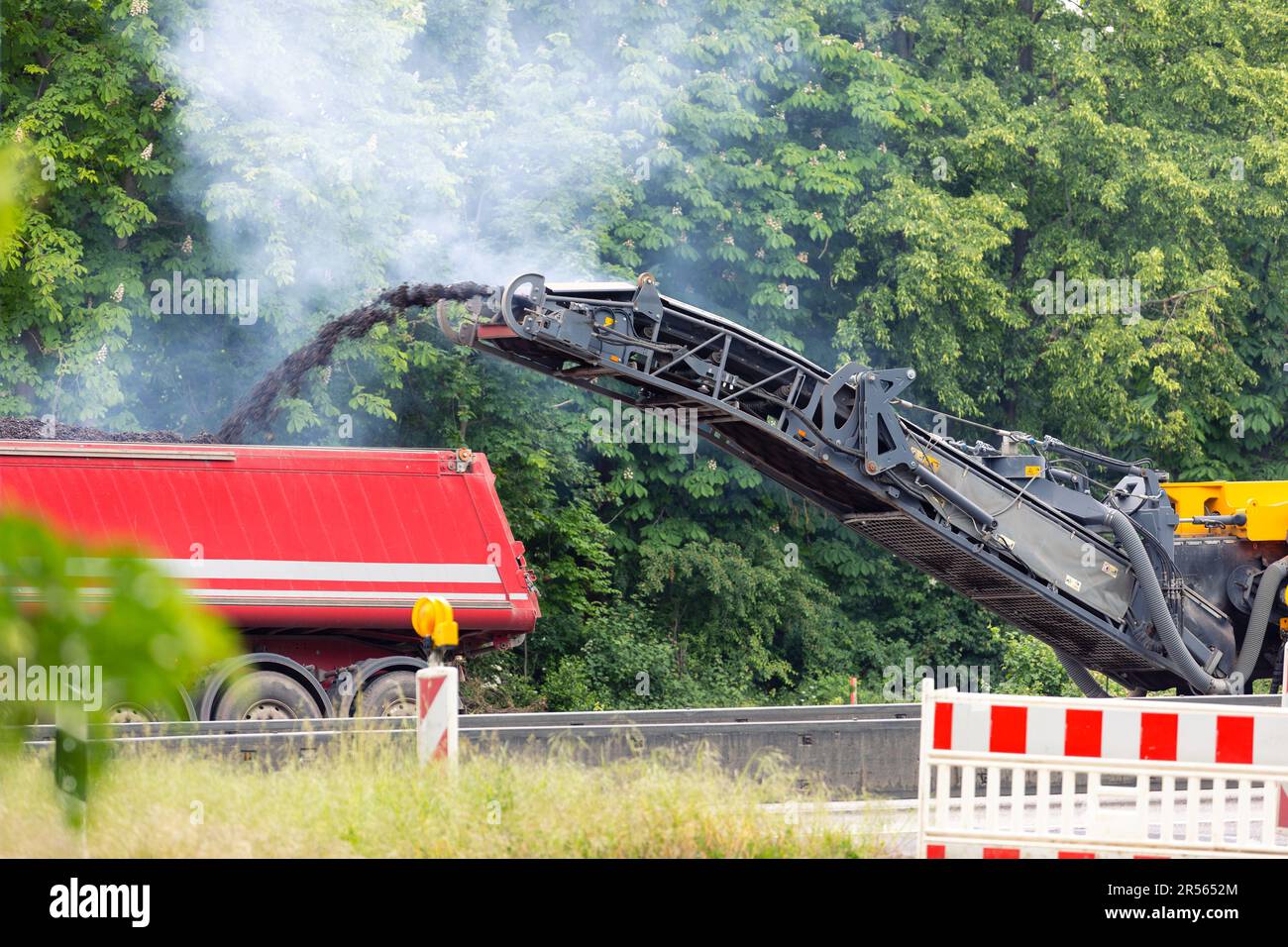 Asphalt milling and grinding machine at road repair and construction ...