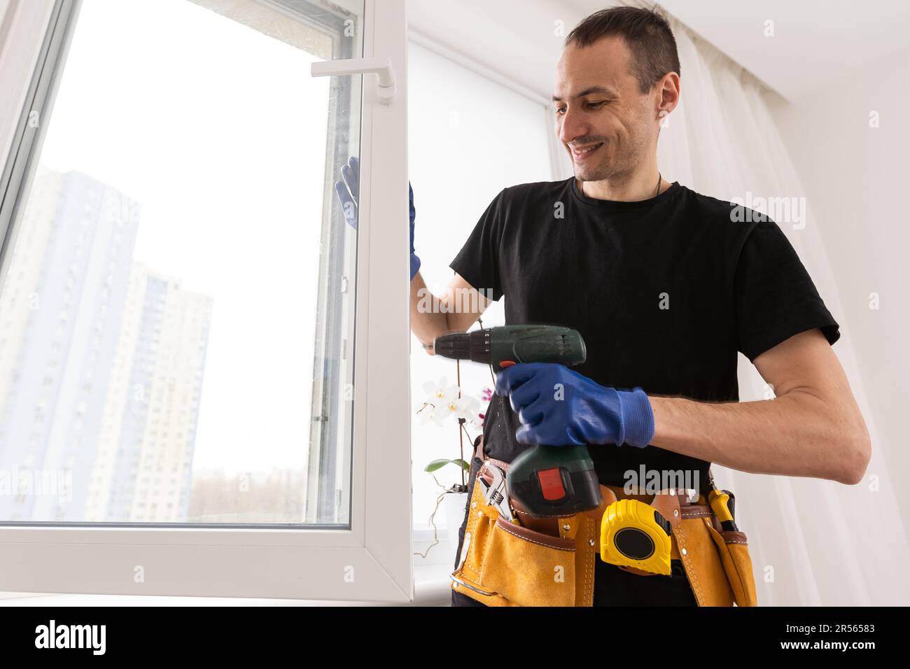 male industrial builder worker at window installation in building ...