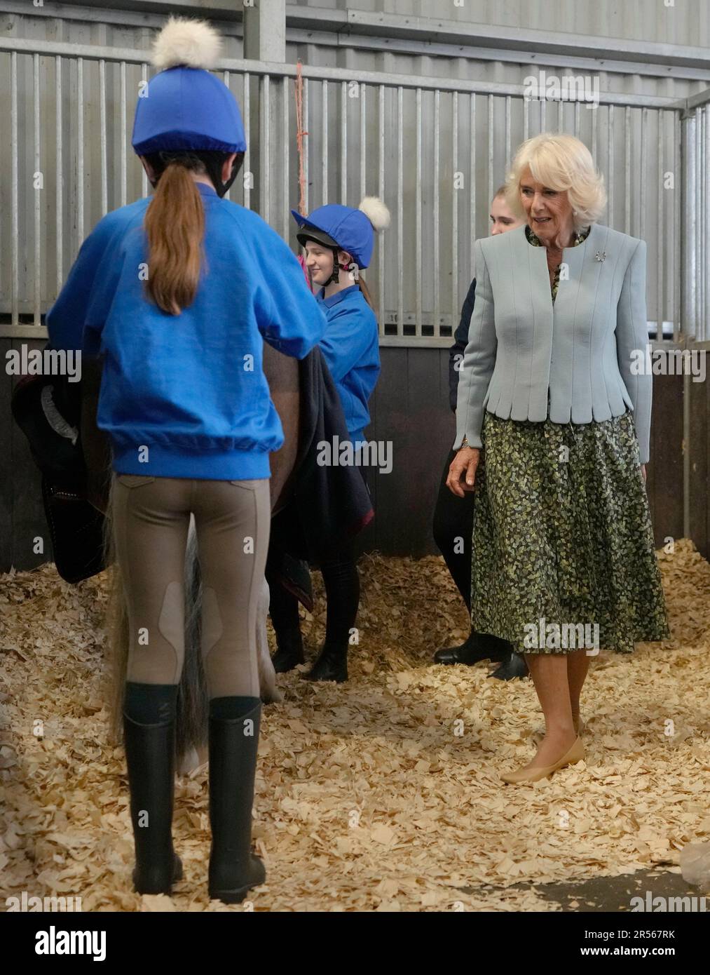 Britain's Queen Camilla watches students in the Newmarket Pony Academy ...