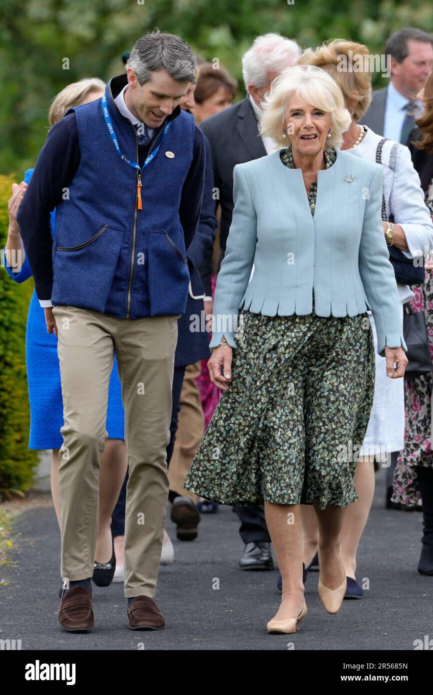 Queen Camilla walks with Chief Executive Andrew Braithwaite as she ...