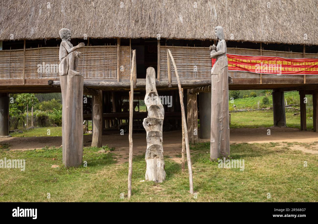 Tree trunk steps rising to the entrance of a traditional "nha rong", or ...