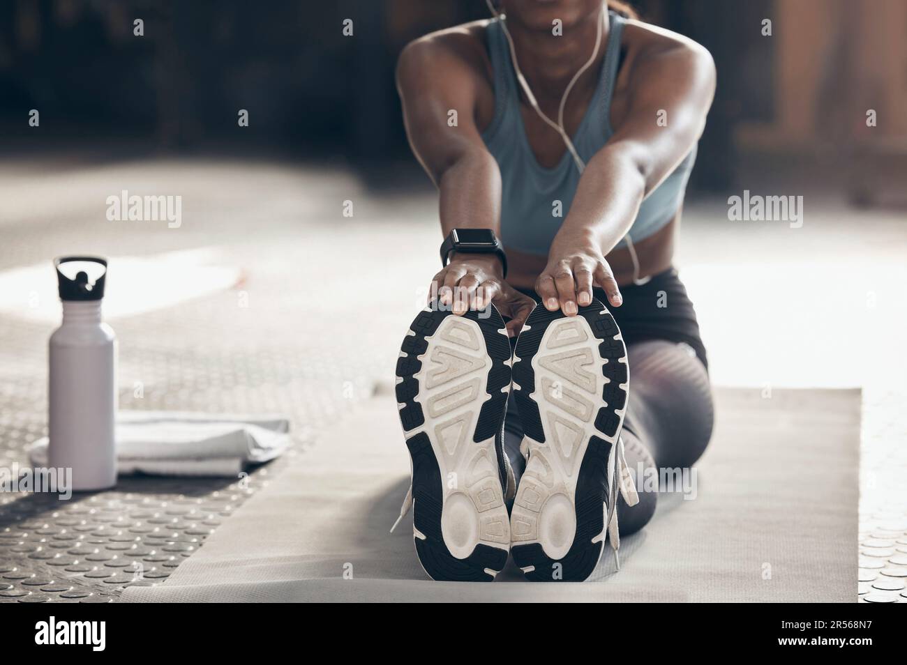 Woman is stretching in gym, fitness and feet with workout start ...