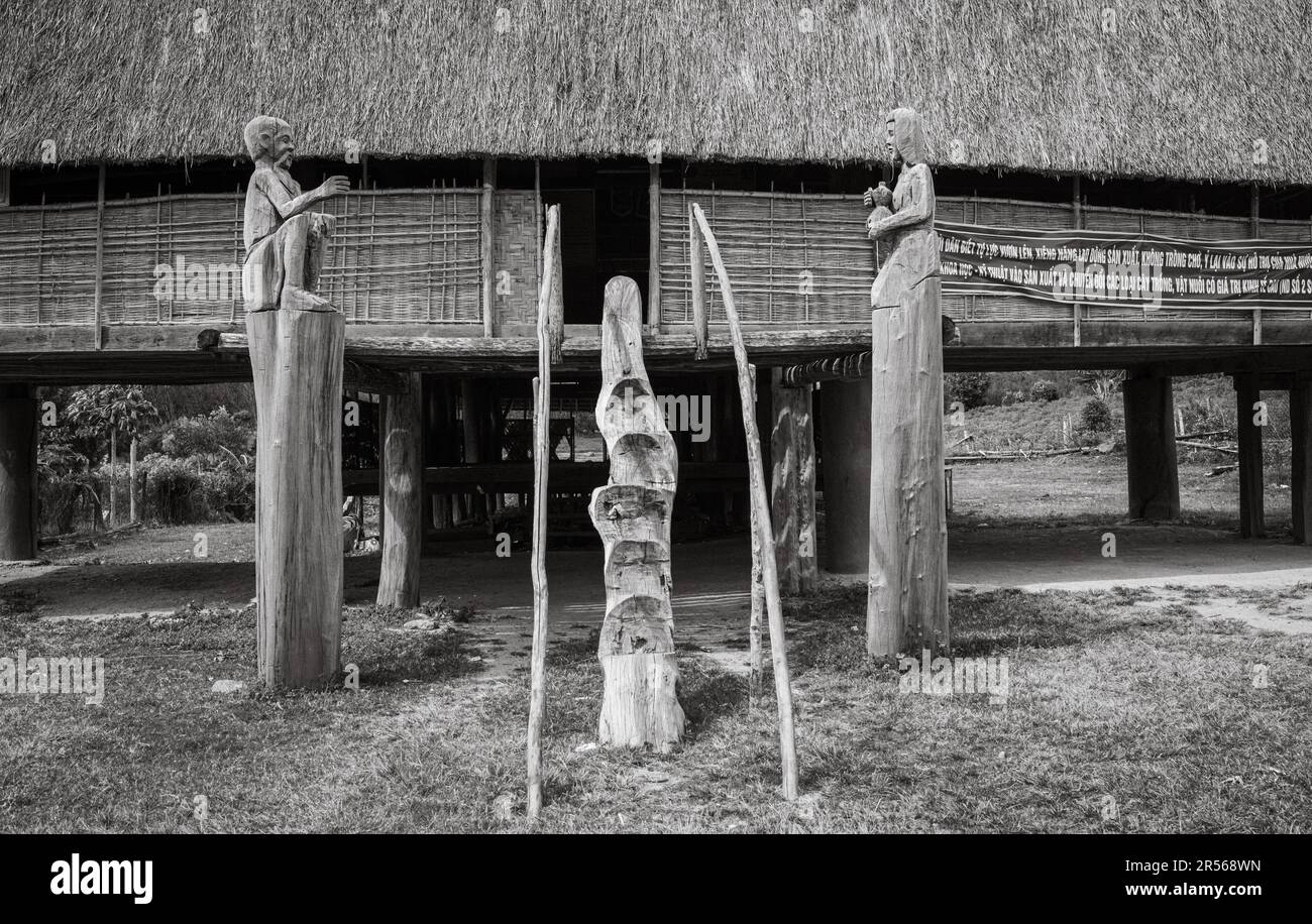Tree trunk steps rising to the entrance of a traditional "nha rong", or ...