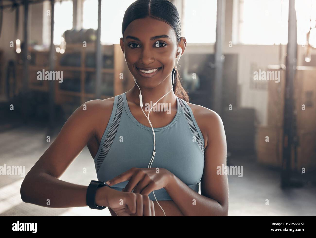 Woman, gym portrait and point at watch, fitness or schedule for workout ...