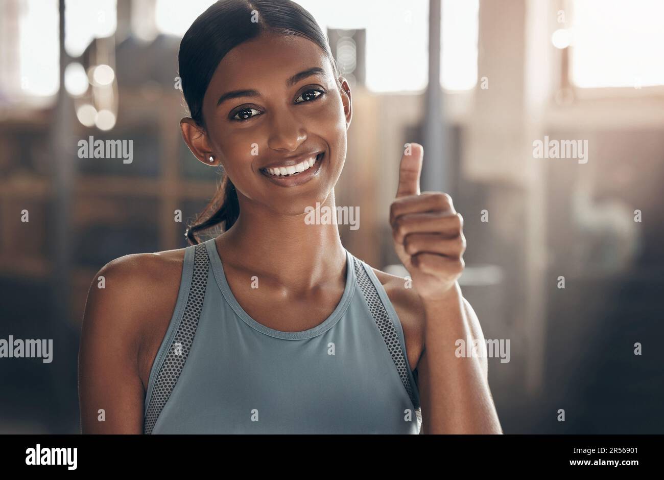 Woman in gym, thumbs up in portrait and fitness with like emoji, smile ...