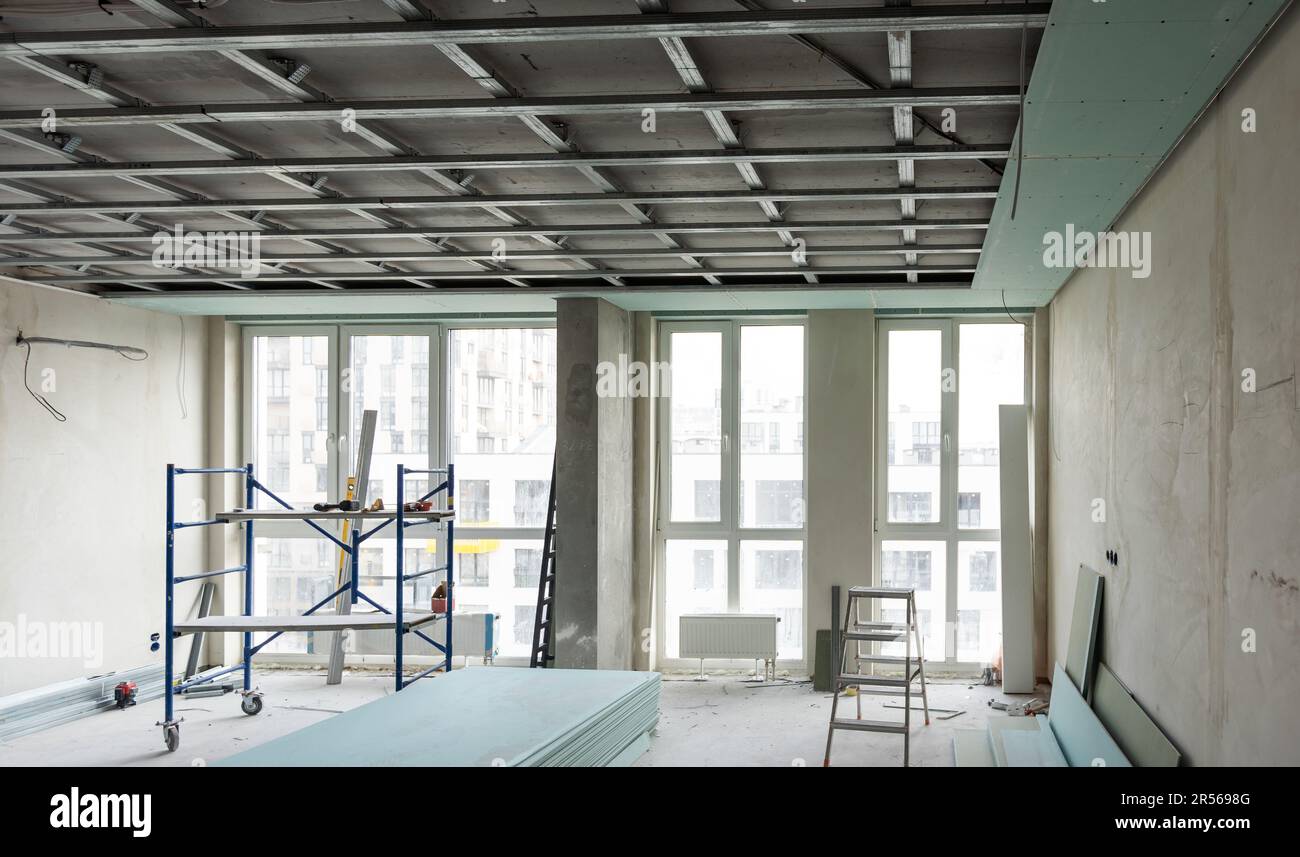 Construction worker, making walls from gypsum plasterboard or drywall ...