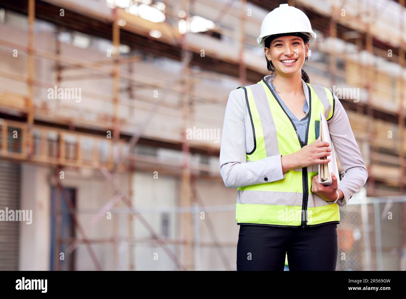 Portrait, engineer and woman with construction, business and smile with ...