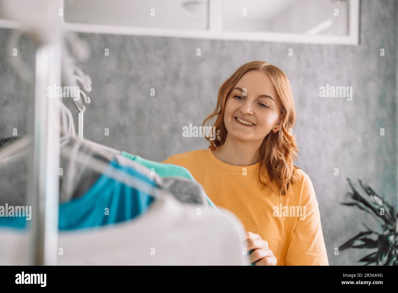 Image of pleased Caucasian young adult woman using cell phone, reading ...
