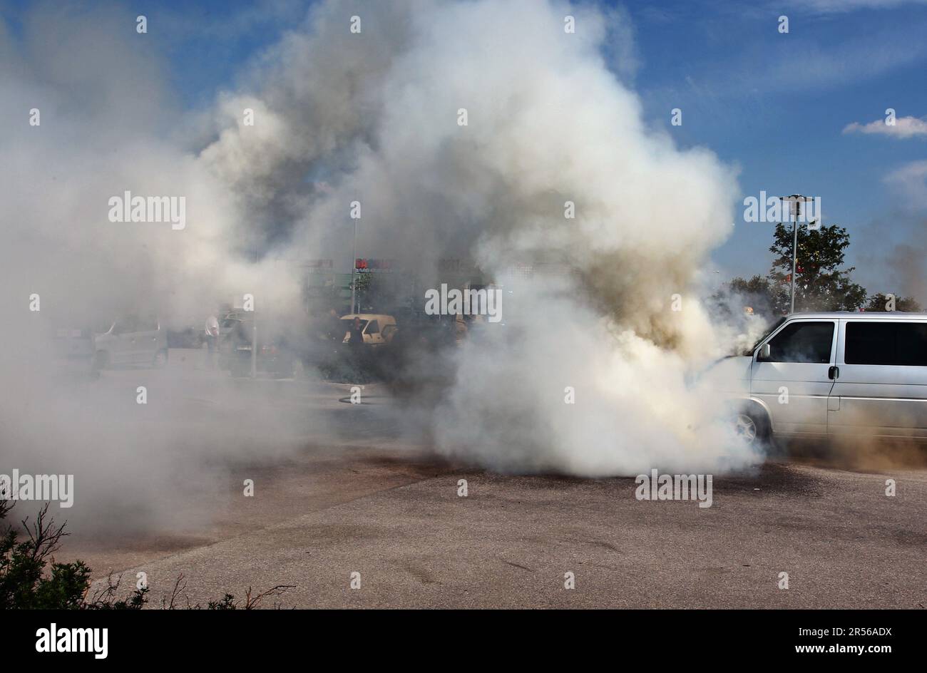 A heavy fire in a van in a parking lot Stock Photo - Alamy