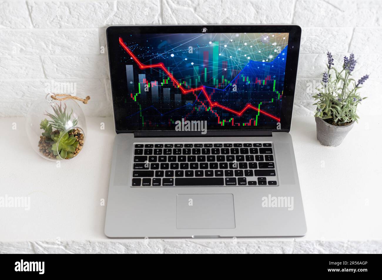 laptop with real estate falling graph Stock Photo - Alamy