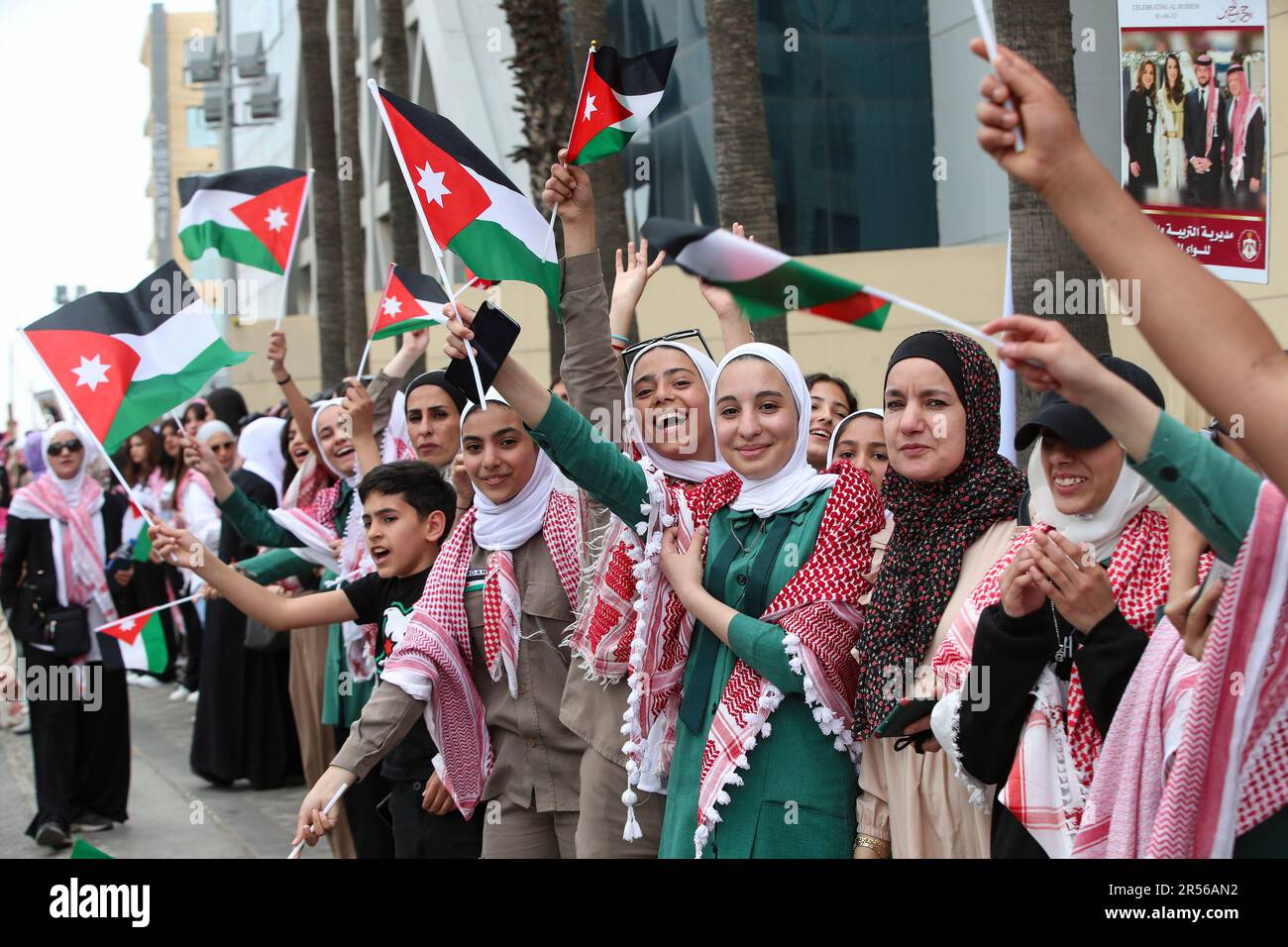 Jordanians wave the national flags in anticipation of the royal ...