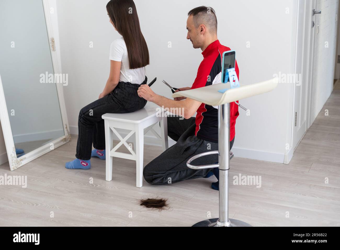 Father cutting hair of teenage daughter at home Stock Photo - Alamy