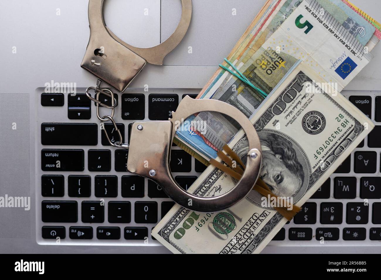 Police handcuffs lie on a lot of dollar bills. The concept of illegal ...