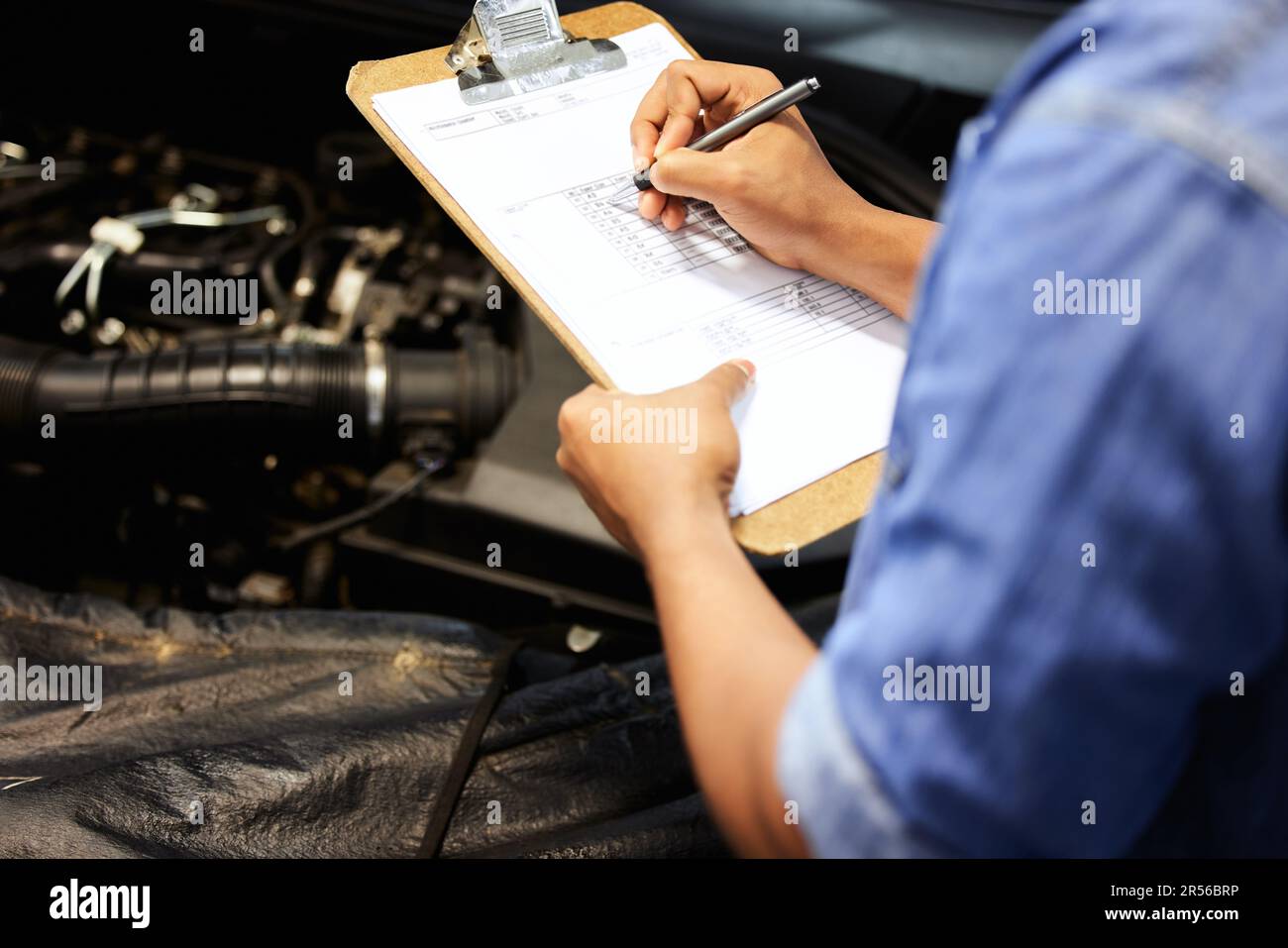 Hands, car mechanic and writing on checklist for service, maintenance ...