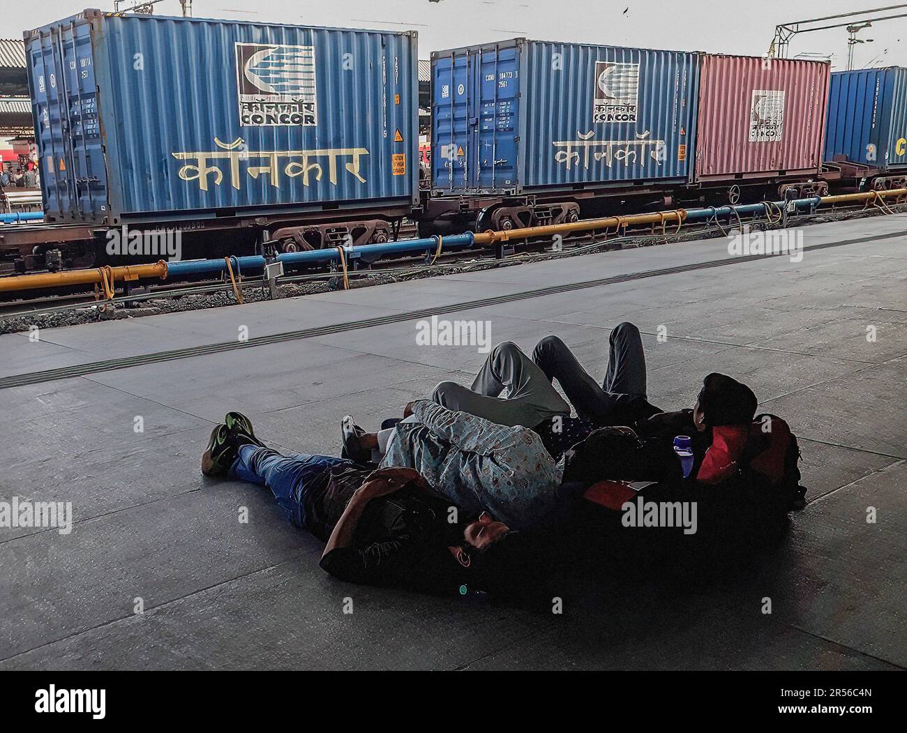 Ujjain, India. 31st May, 2023. People rest along a platform as a ...