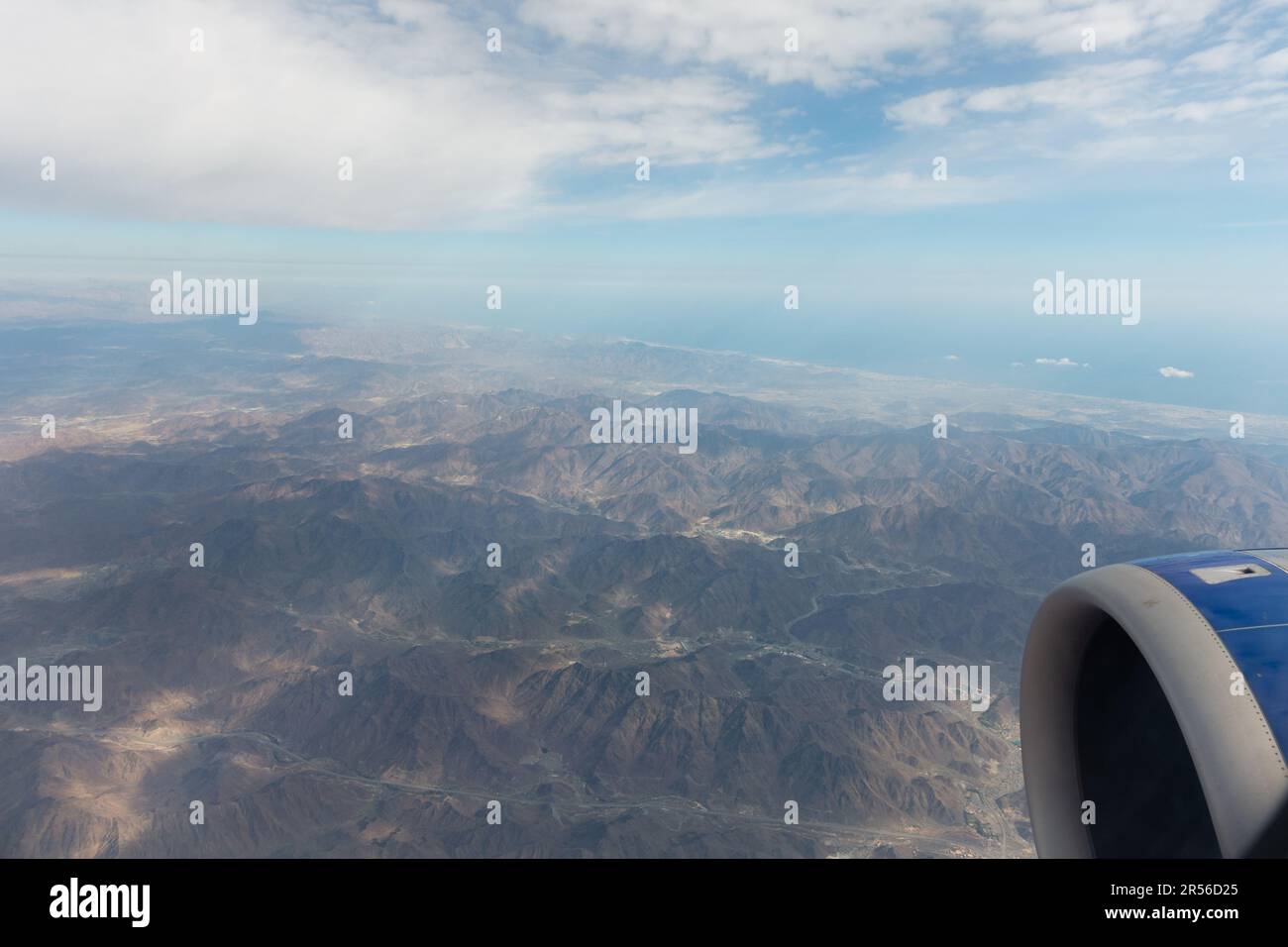 Aeroplane window aerial view of the landscape with the overhead clouds ...