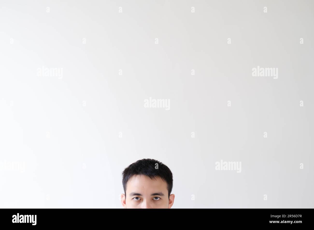 Wide shot of a partial face of a young Asian man's head with eyes ...