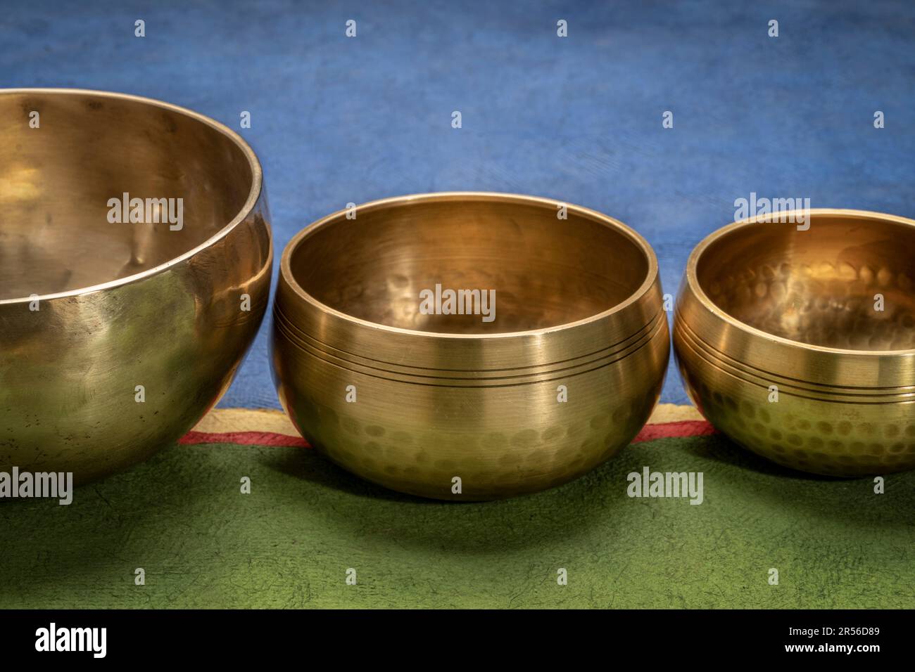 handmade Tibetan singing bowls against abstract paper landscape, sound ...