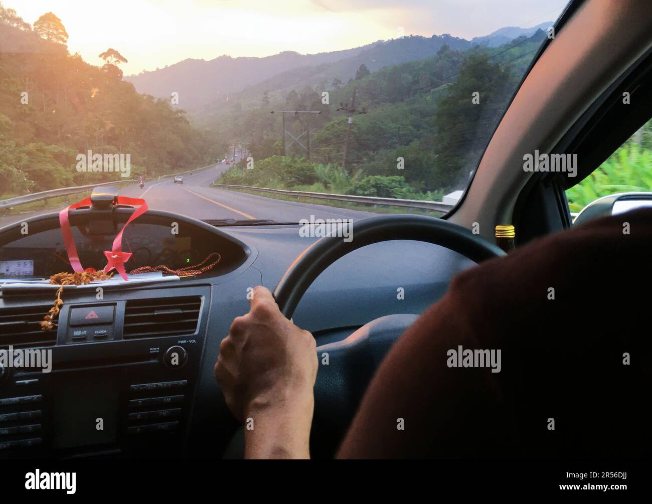 Driving concept, Hand driving a car on the road blurred background ...