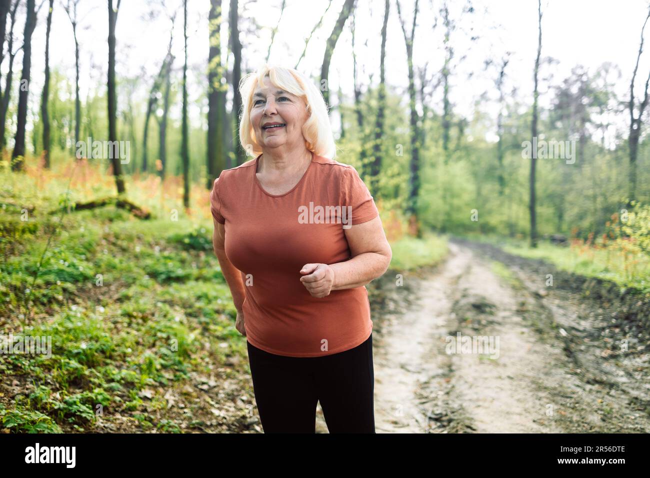 Portrait of a happy active beautiful senior caucasian woman running ...