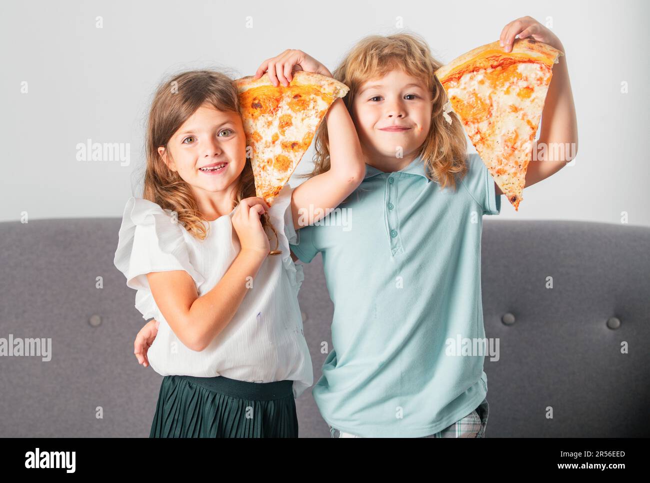 Pizza and kids, slices pizza in kids hand. Children eating tasty fast ...