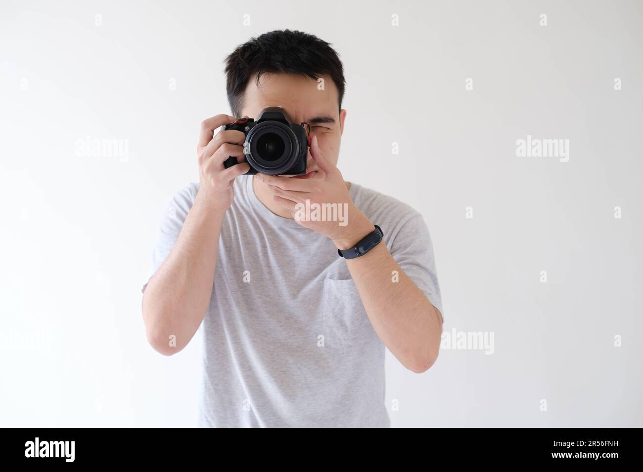Young professional photographer using dslr hi-res stock photography and ...