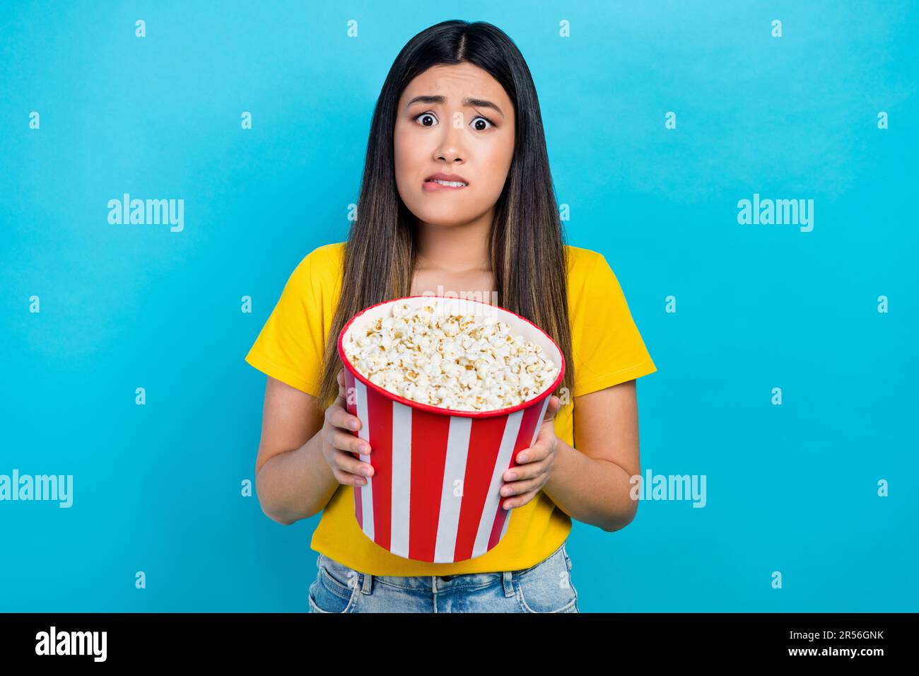 Photo of young nervous frightened girl korean hold bucket popcorn ...