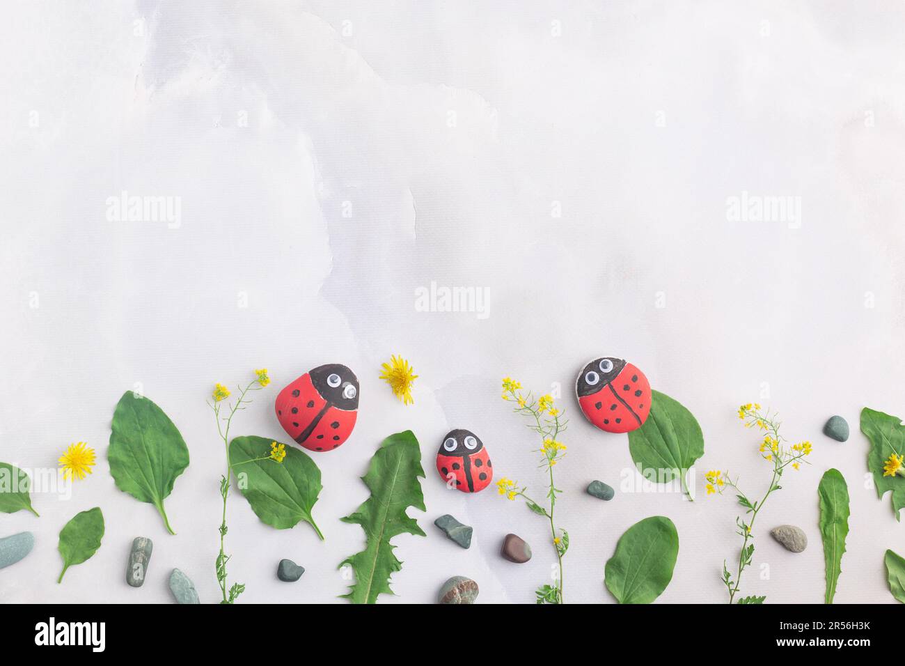 Drawing a ladybug on a stone with acrylic paints. Home hobbies are ...