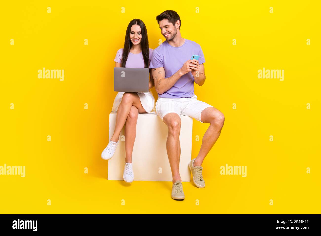 Full length photo of lovely young lady guy sit cube netbook device ...