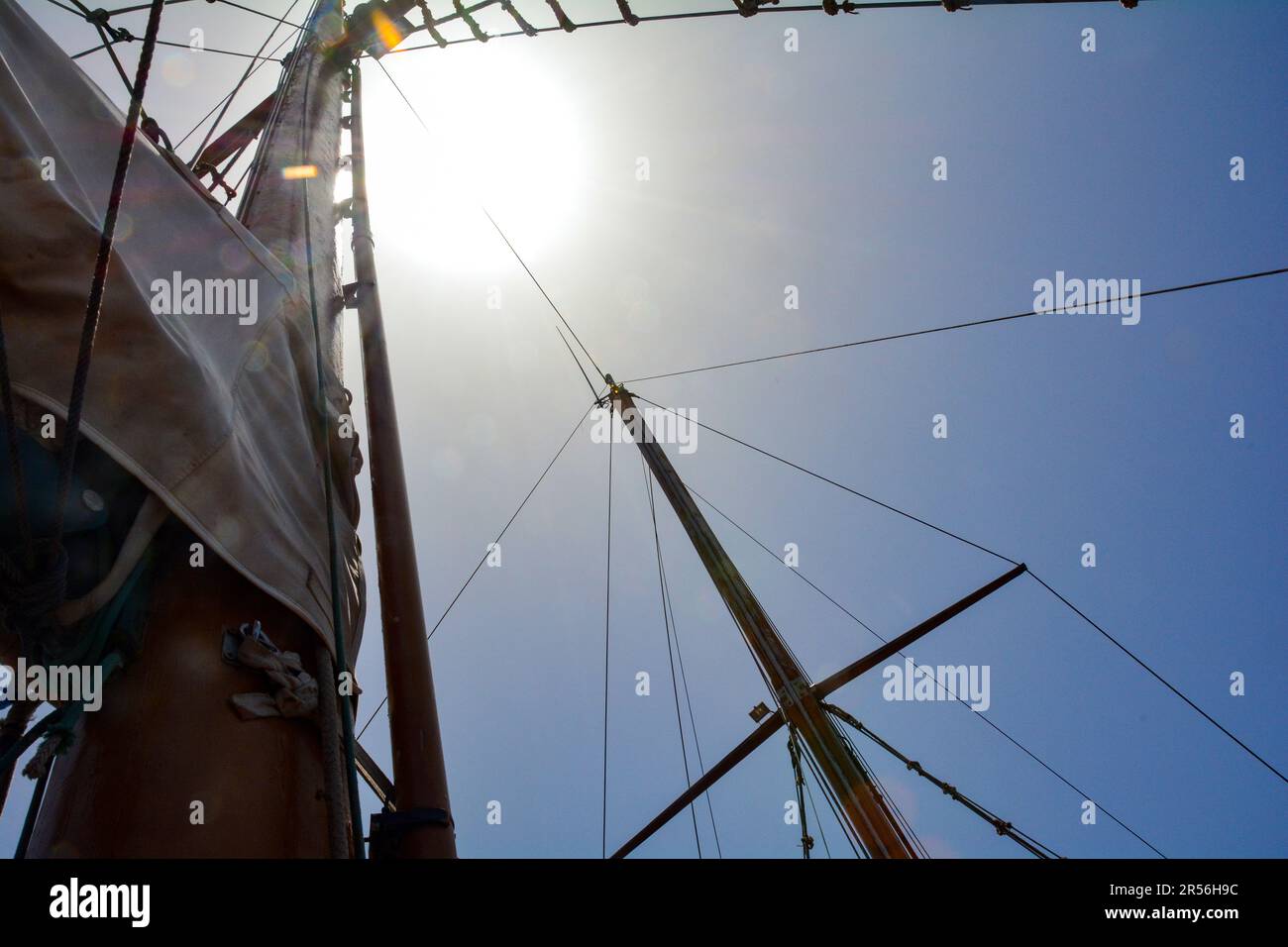 Mast of a sailing ship with no sails set with blue sky Stock Photo - Alamy