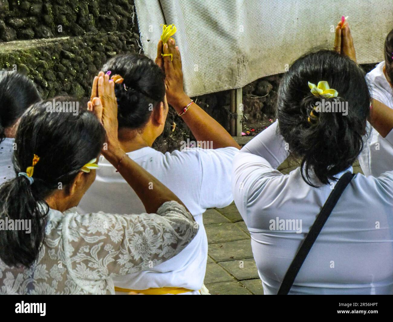 Bali Hinduism, devout people praying in front of shrine in Taman Beji ...