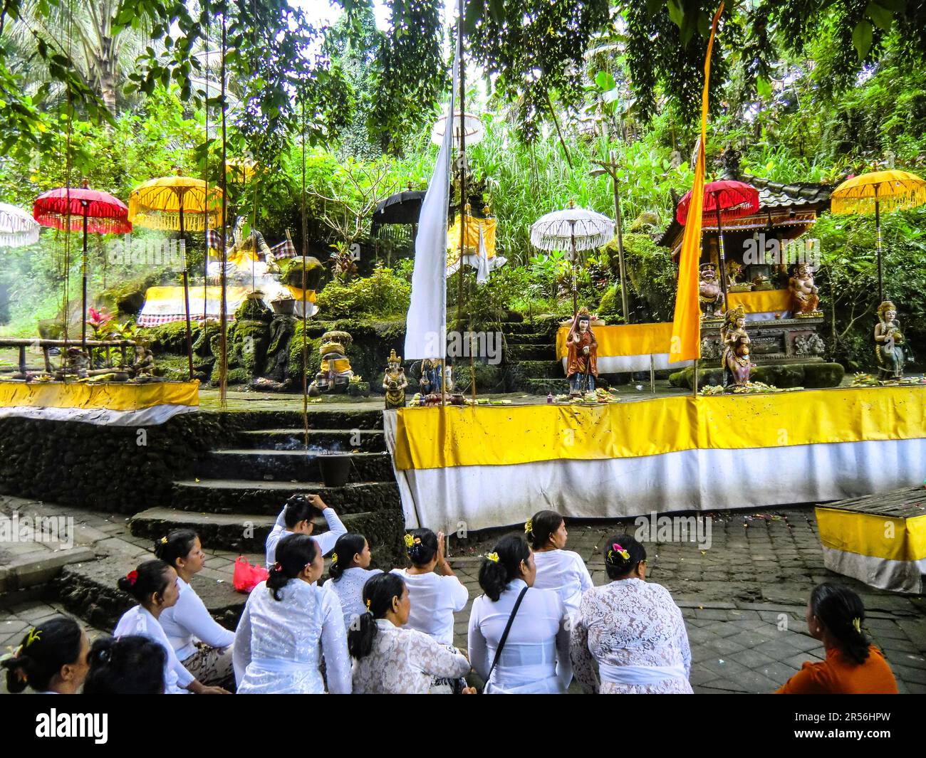 Bali Hinduism, devout people praying in front of shrine in Taman Beji ...