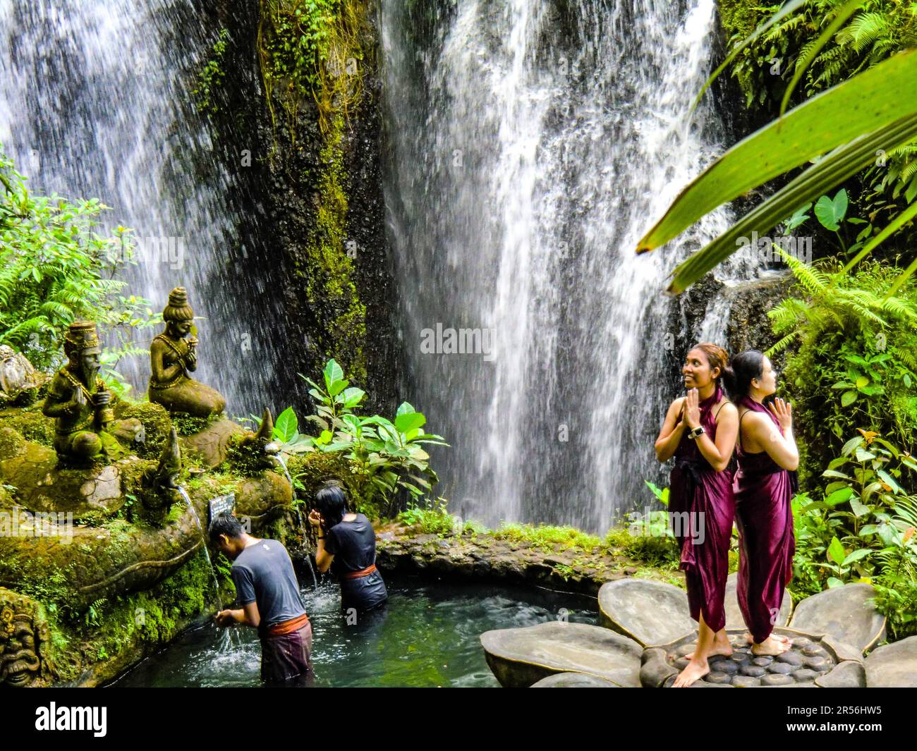 Devout people praying in water at Taman Beji Griya Waterfall, Kabupaten ...