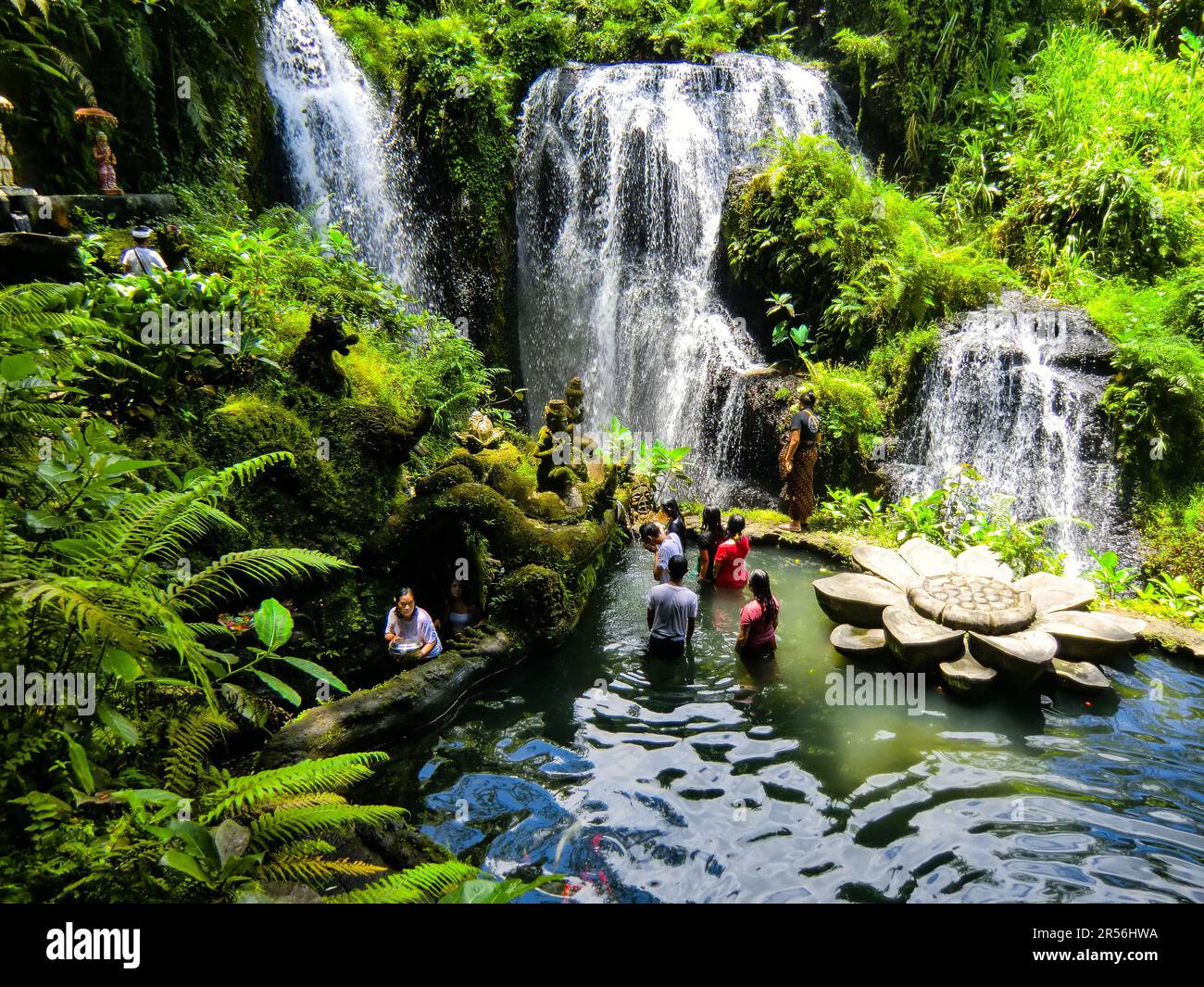 Devout people praying in water at Taman Beji Griya Waterfall, Kabupaten ...