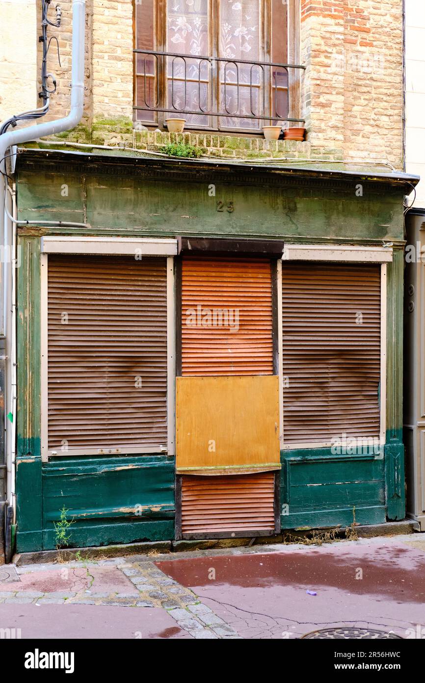 Historic side-streets of Dieppe. Close up of old boarded up shop front ...
