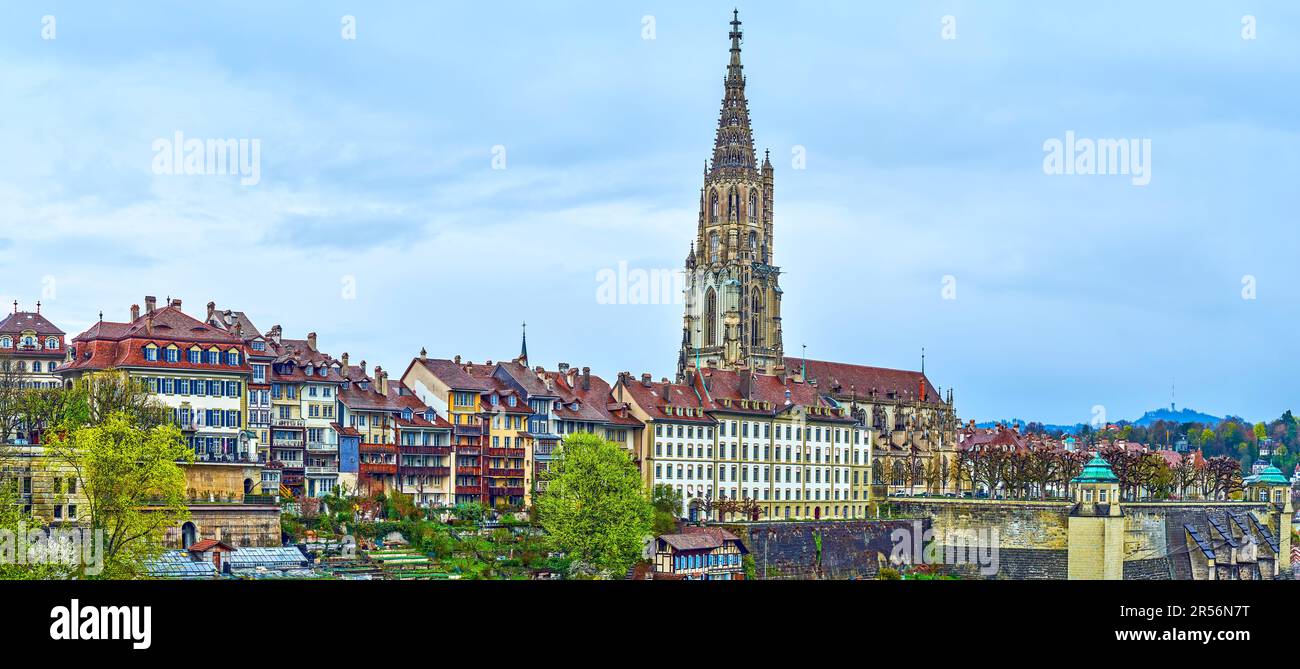 High stone bell tower of Bern Minster Cathedral over the roofs of ...