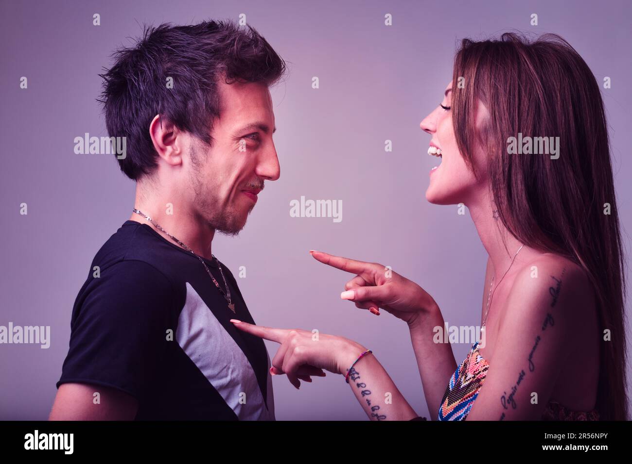 Playful taps on her boyfriend's chest, a young woman's childlike ...