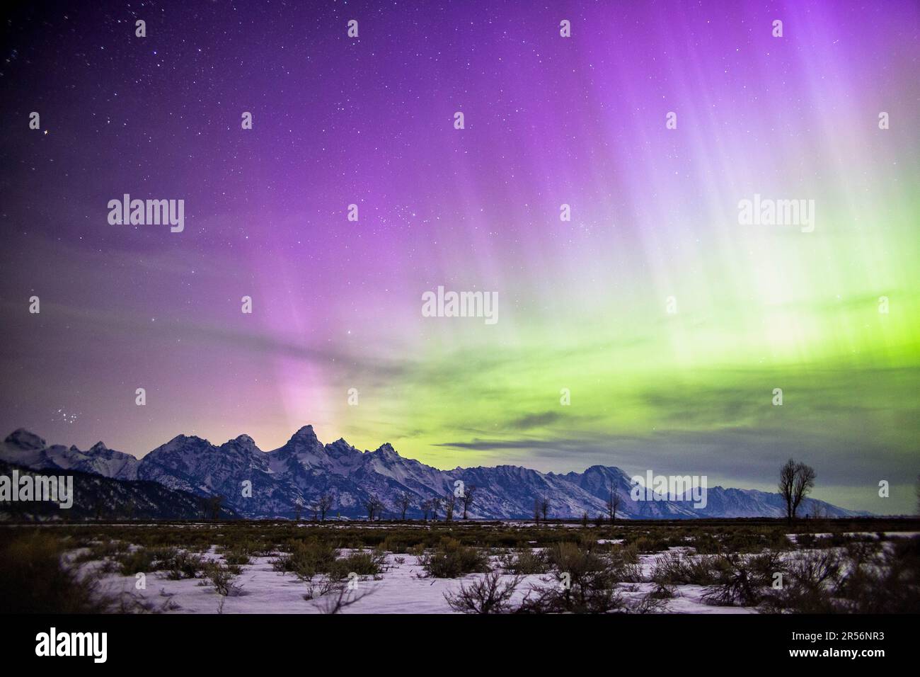 Ribbons from the northern lights streaking over the Teton Mountains and ...