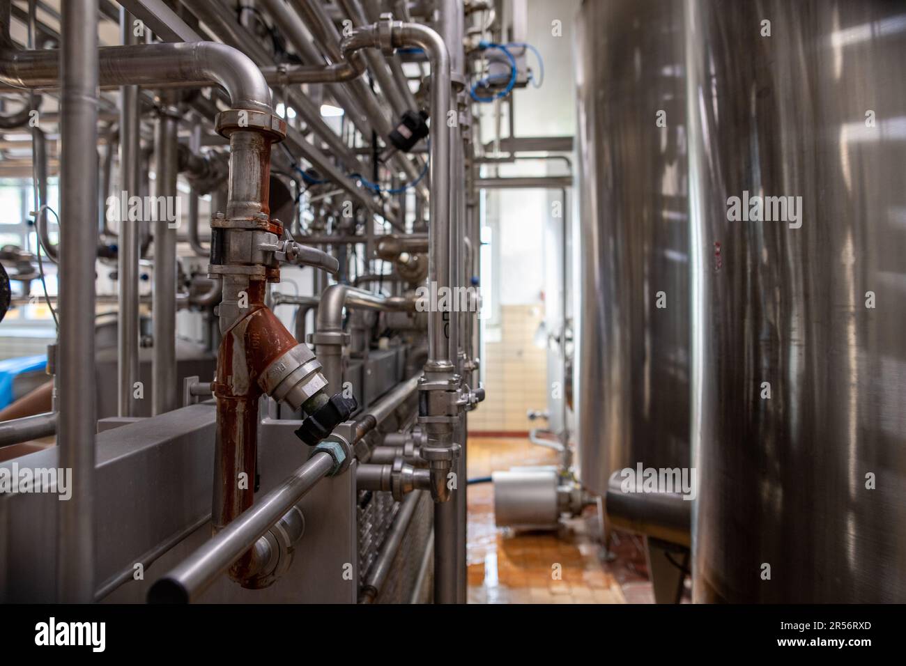 Interior of a modern manufacture with stainless steel tanks and pipes ...