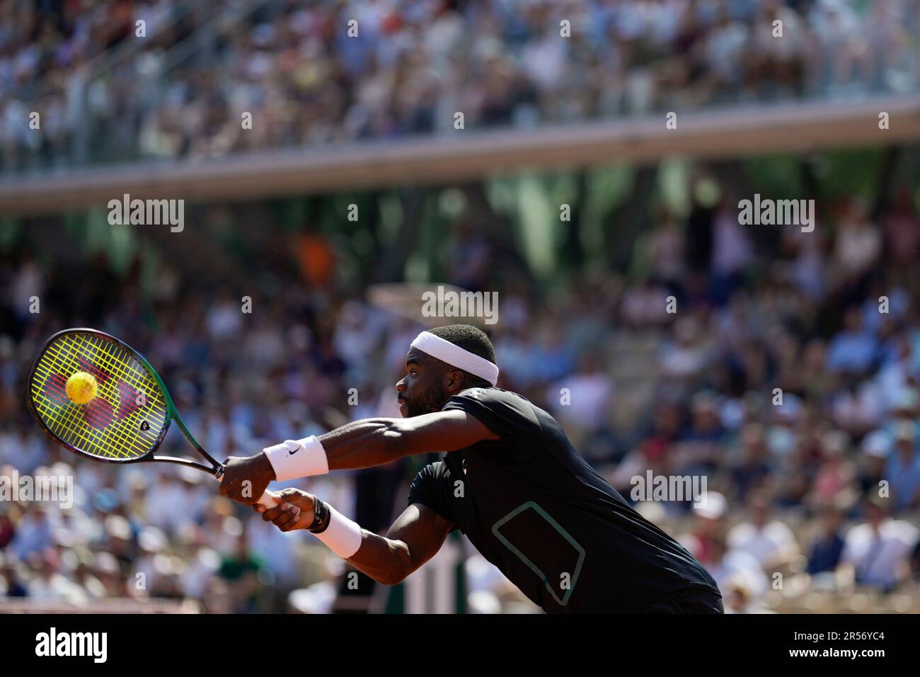Frances Tiafoe of the U.S. plays a shot against Russia's Aslan Karatsev ...