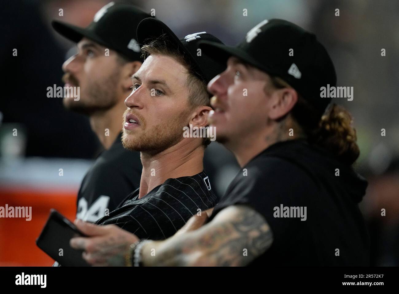 Chicago White Sox starting pitcher Michael Kopech, center, sits in the dugout between Dylan ...