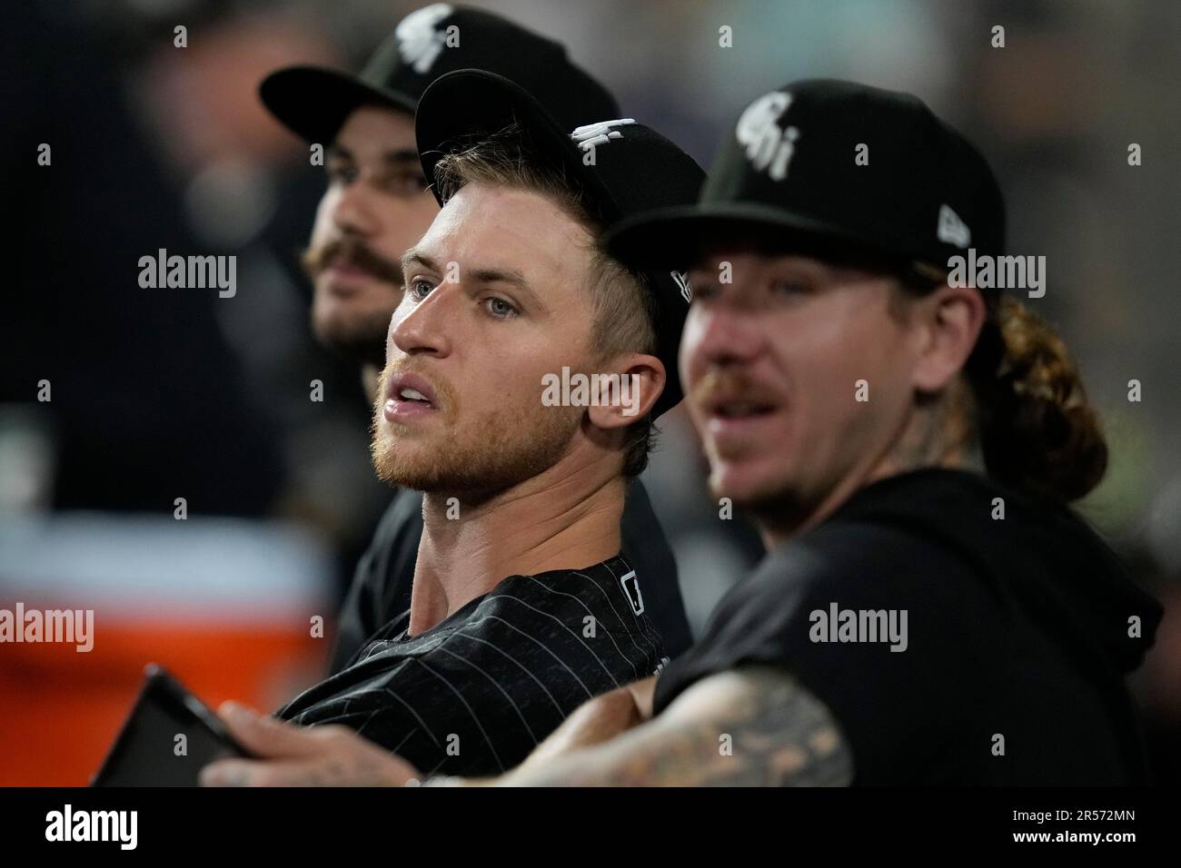Chicago White Sox starting pitcher Michael Kopech, center, sits in the dugout between Dylan ...