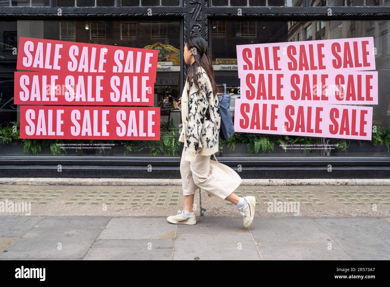London, UK. 1 June 2023. A woman passes the windows of Liberty ...