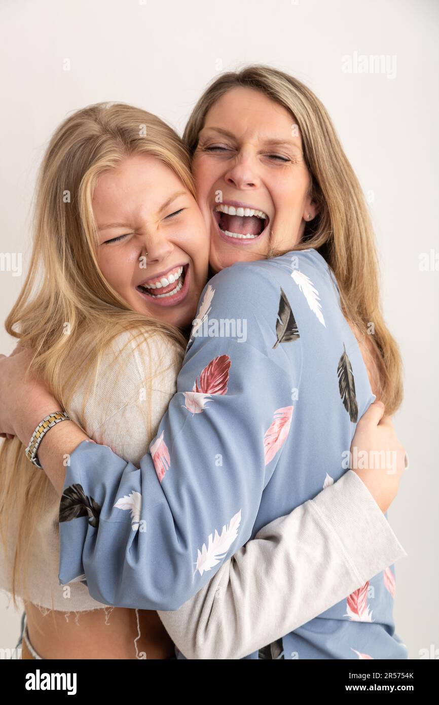 Portrait of mother and adult daughter embracing Stock Photo - Alamy