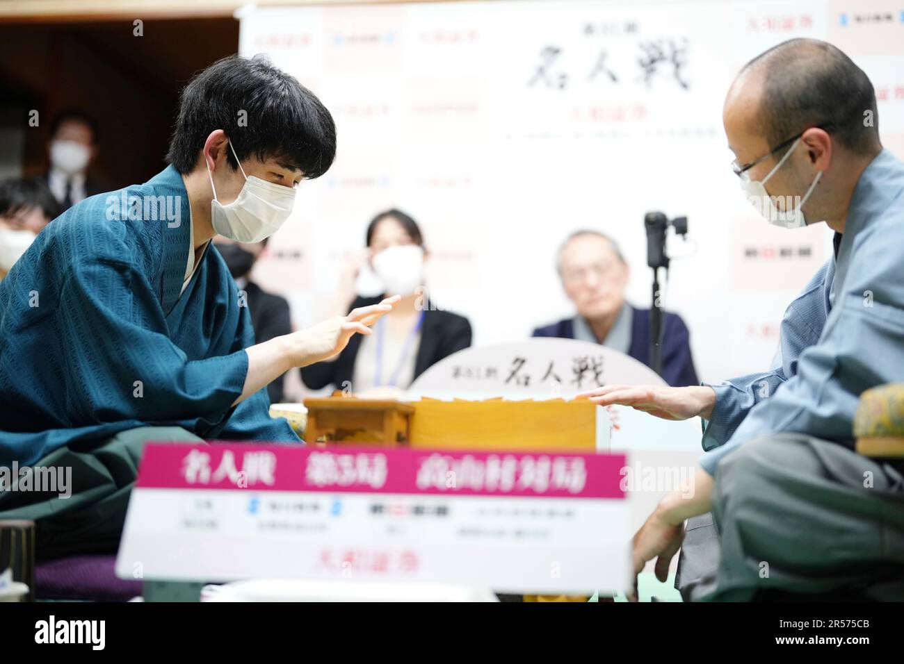 Shogi player Sota Fujii (L) reviews the Meijin title against Akira ...