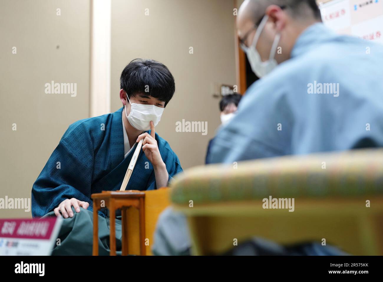Shogi player Sota Fujii (L) speaks about his new "Meijin" title during ...