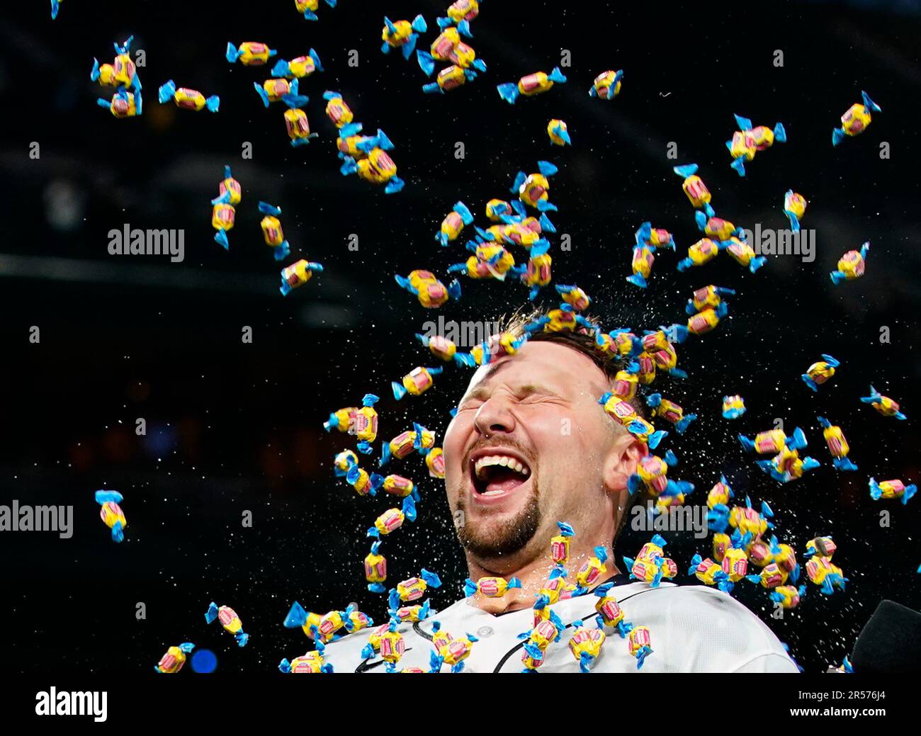 Seattle Mariners' Cal Raleigh laughs as a teammate throws bubble gum at ...